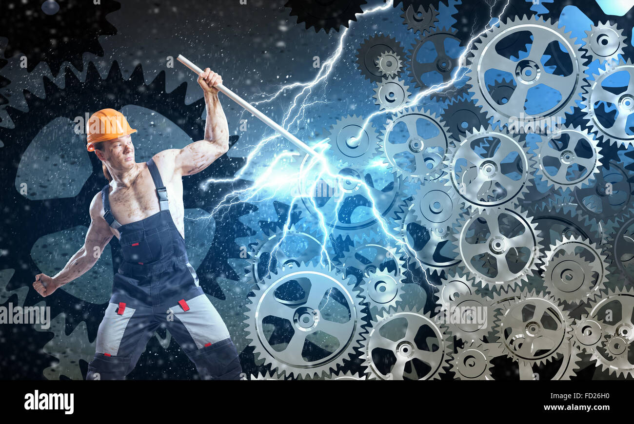 Strong man mechanic in uniform with spanner fixing mechanism Stock ...