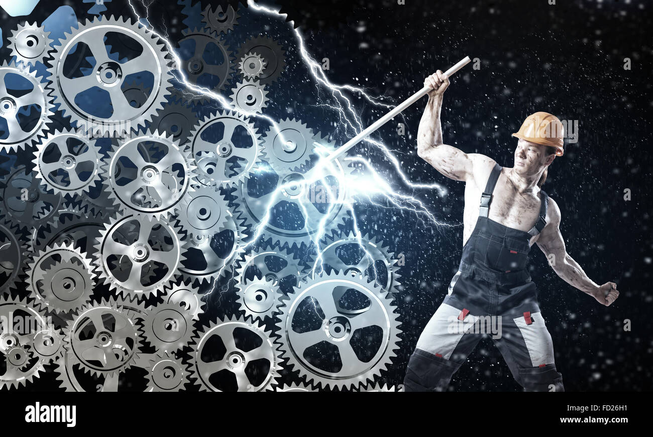 Strong man mechanic in uniform with spanner fixing mechanism Stock ...