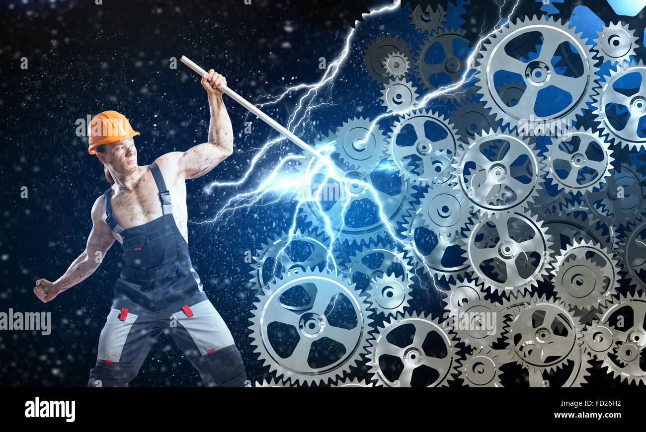 Strong man mechanic in uniform with spanner fixing mechanism Stock ...