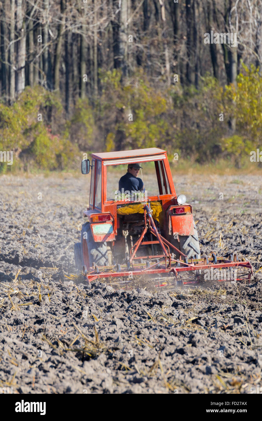 Farmer in Tractor Preparing Land for Sowing, Agriculture and Working ...