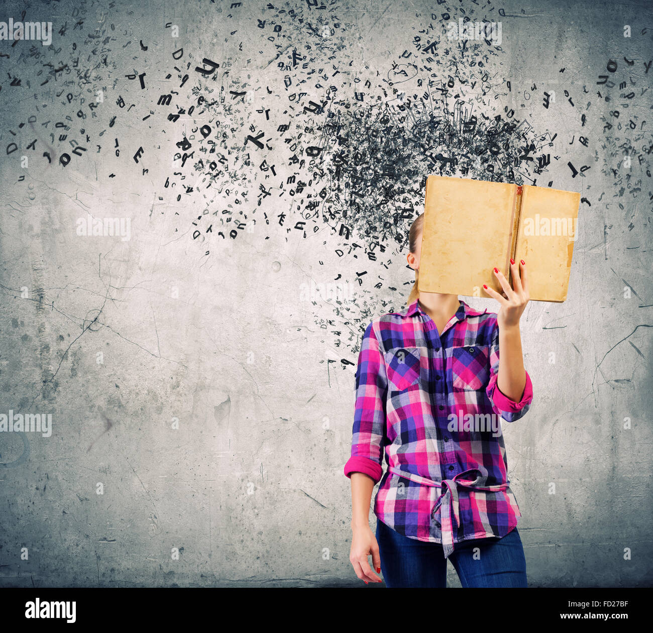 Young woman in casual hiding face behind reading Stock Photo - Alamy