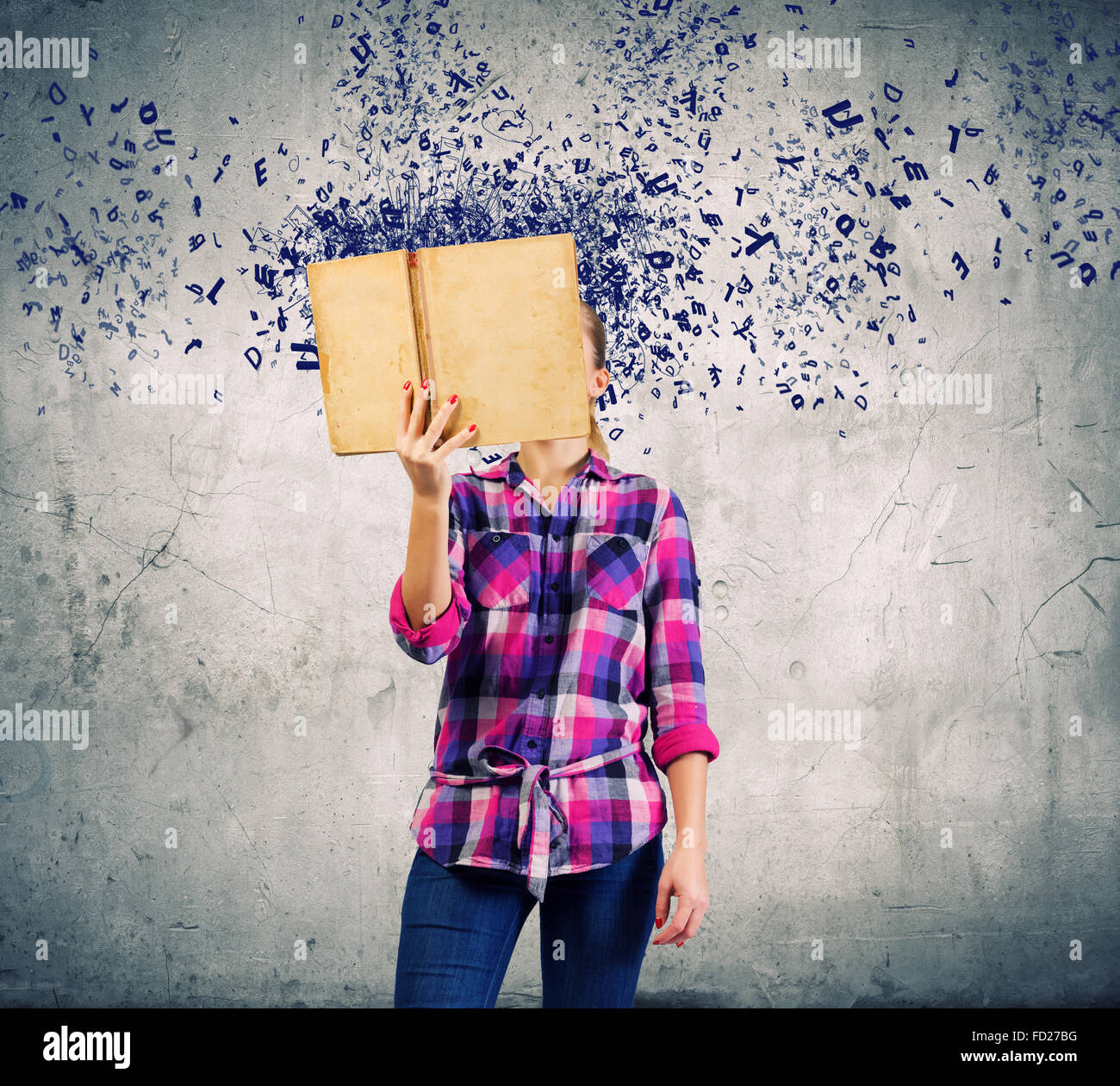 Young woman in casual hiding face behind reading Stock Photo - Alamy