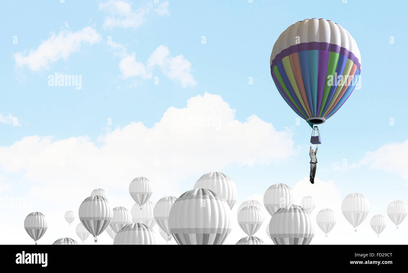 Conceptual image with balloons flying high in sky Stock Photo - Alamy