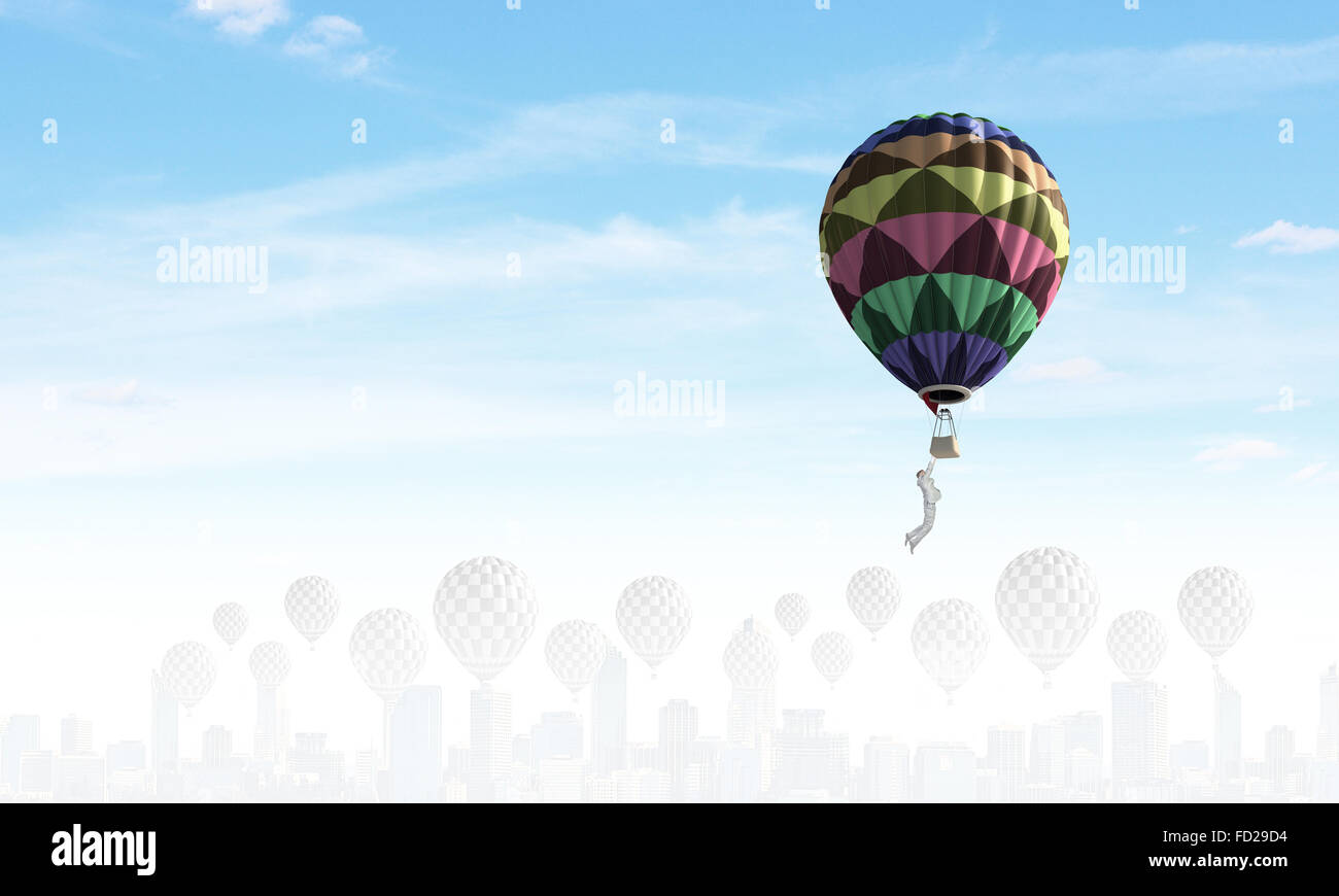 Conceptual image with balloons flying high in sky Stock Photo - Alamy