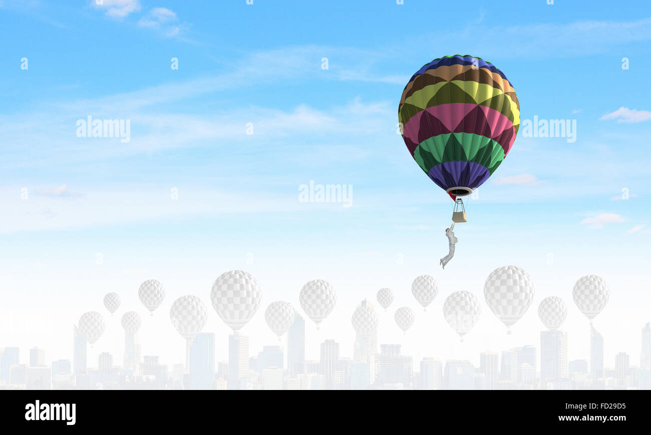 Conceptual image with balloons flying high in sky Stock Photo - Alamy