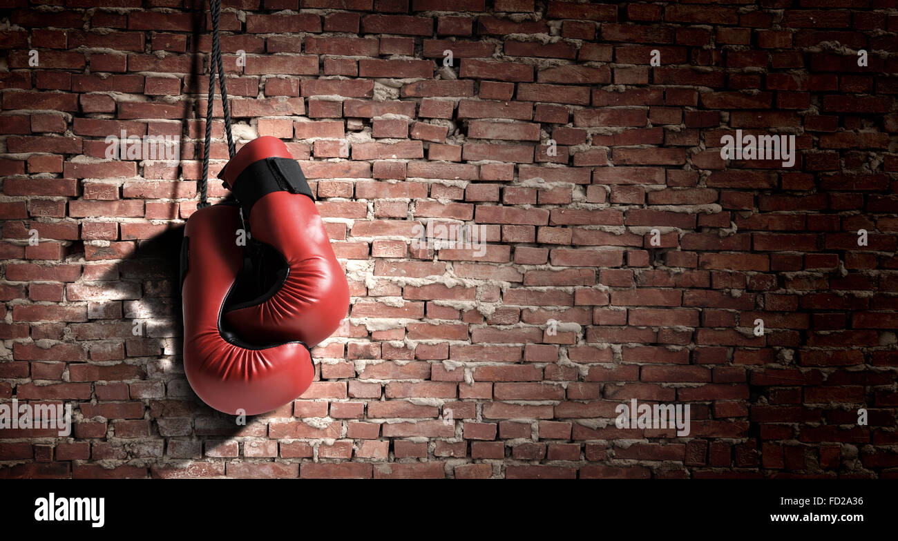 Pair of red boxing gloves hanging on wall Stock Photo - Alamy