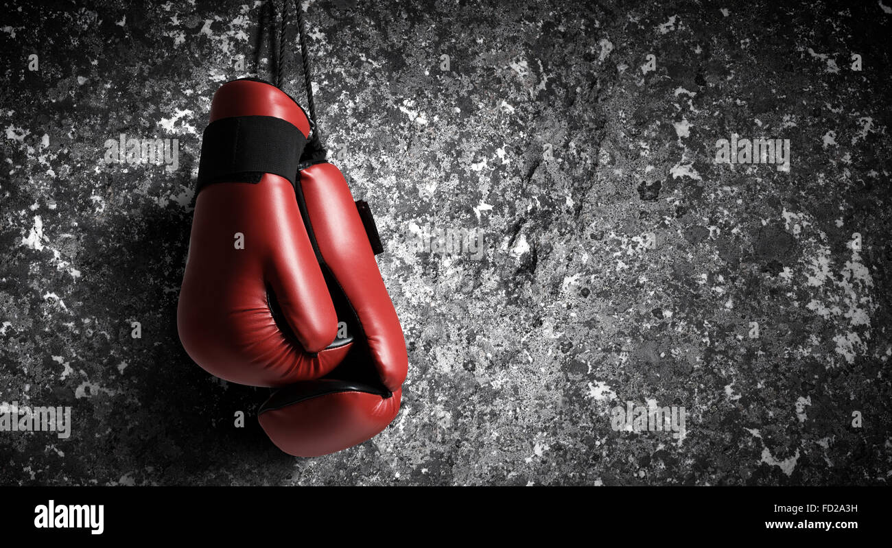 Pair of red boxing gloves hanging on wall Stock Photo - Alamy