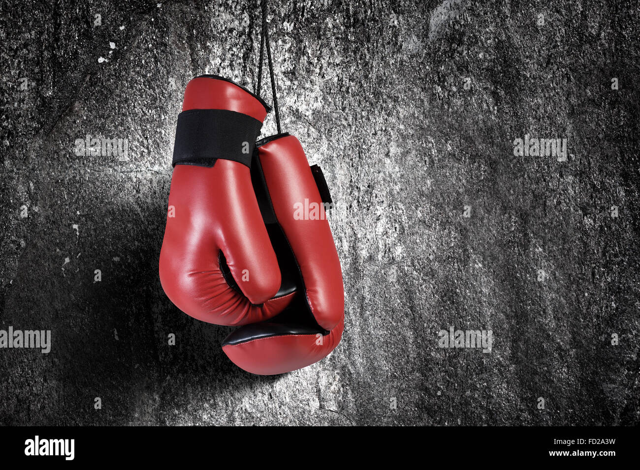 Pair of red boxing gloves hanging on wall Stock Photo - Alamy