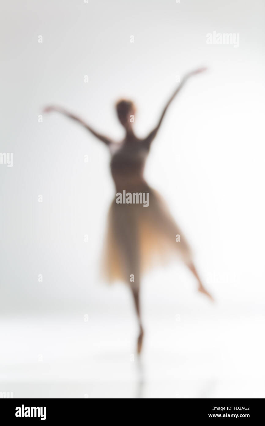 Blurred silhouette of ballerina dancing on white background Stock Photo ...