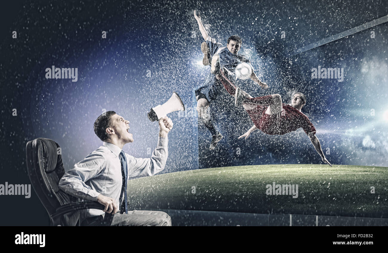 Young man screaming in megaphone and watching football match Stock ...