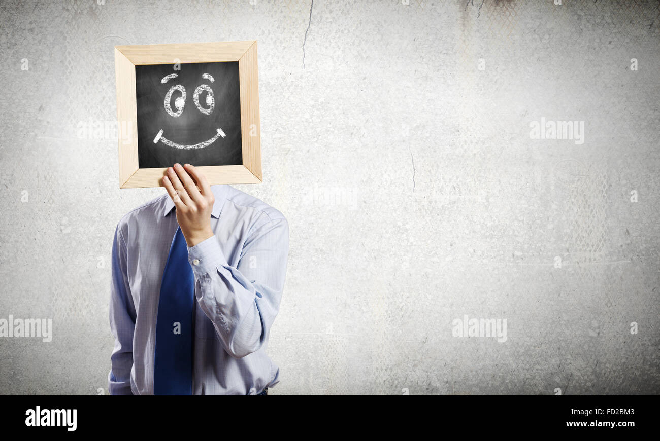 Young smiling businessman holding chalkboard with smiley hi-res stock ...