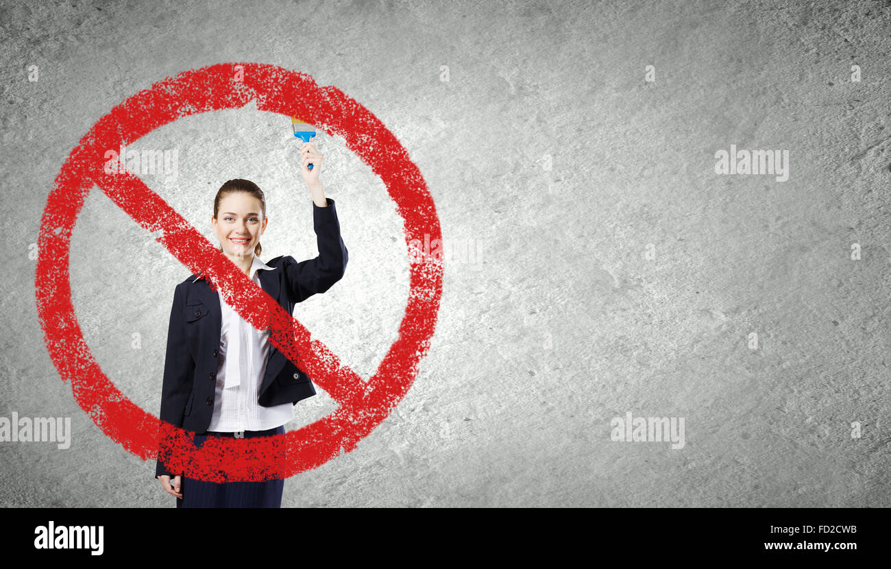 Young businesswoman drawing red prohibition sign with brush Stock Photo ...