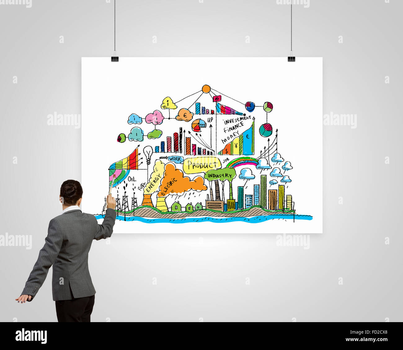 Rear view of businesswoman coloring business sketches with paint brush ...