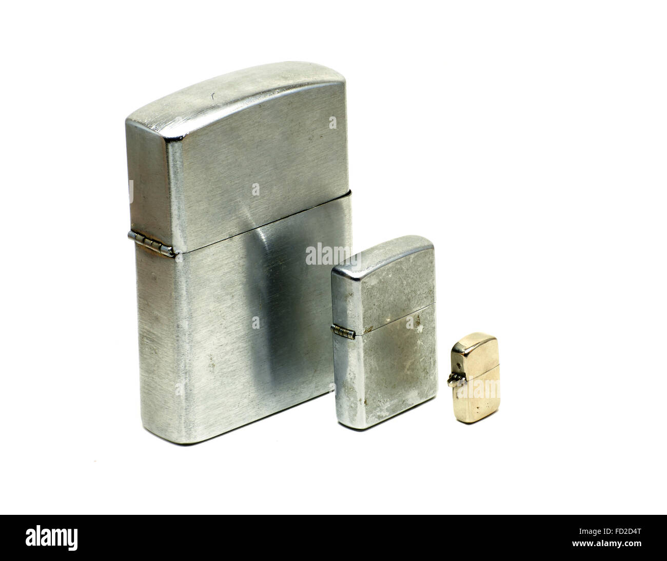 Three different sizes of metallic lighters with cap closed Stock Photo ...