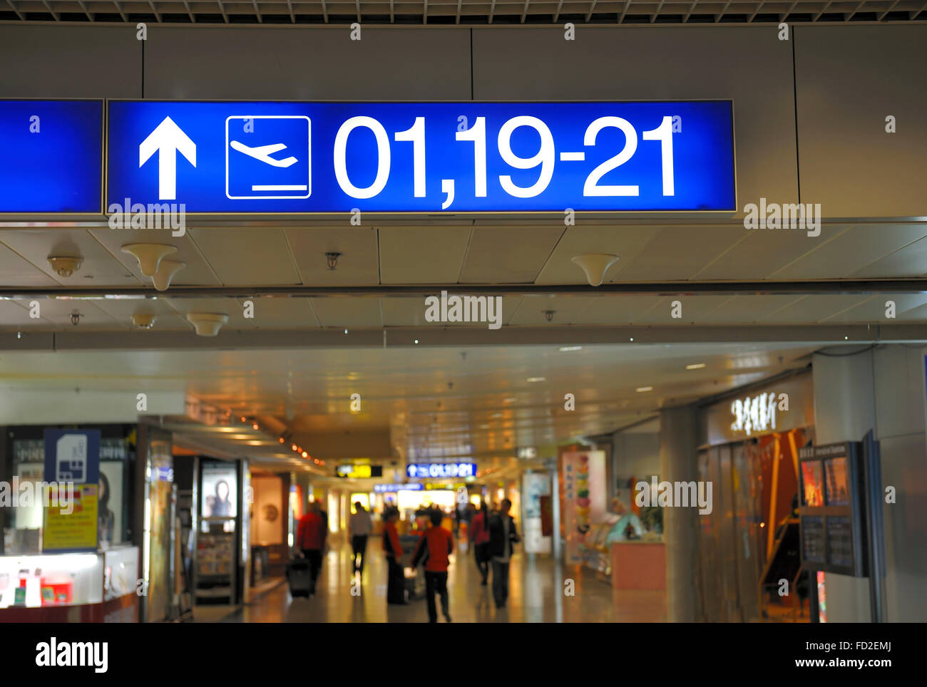 blue signs at airport indicating the route to the gates Stock Photo - Alamy