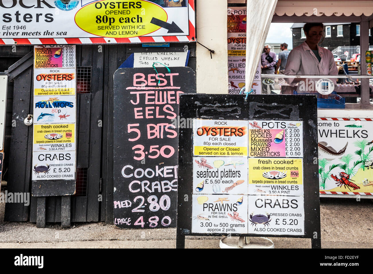 Display boards showing prices of freshly caught seafood outside a stall ...