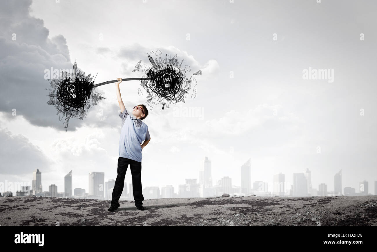 Boy of school age lifting barbell on one hand Stock Photo - Alamy