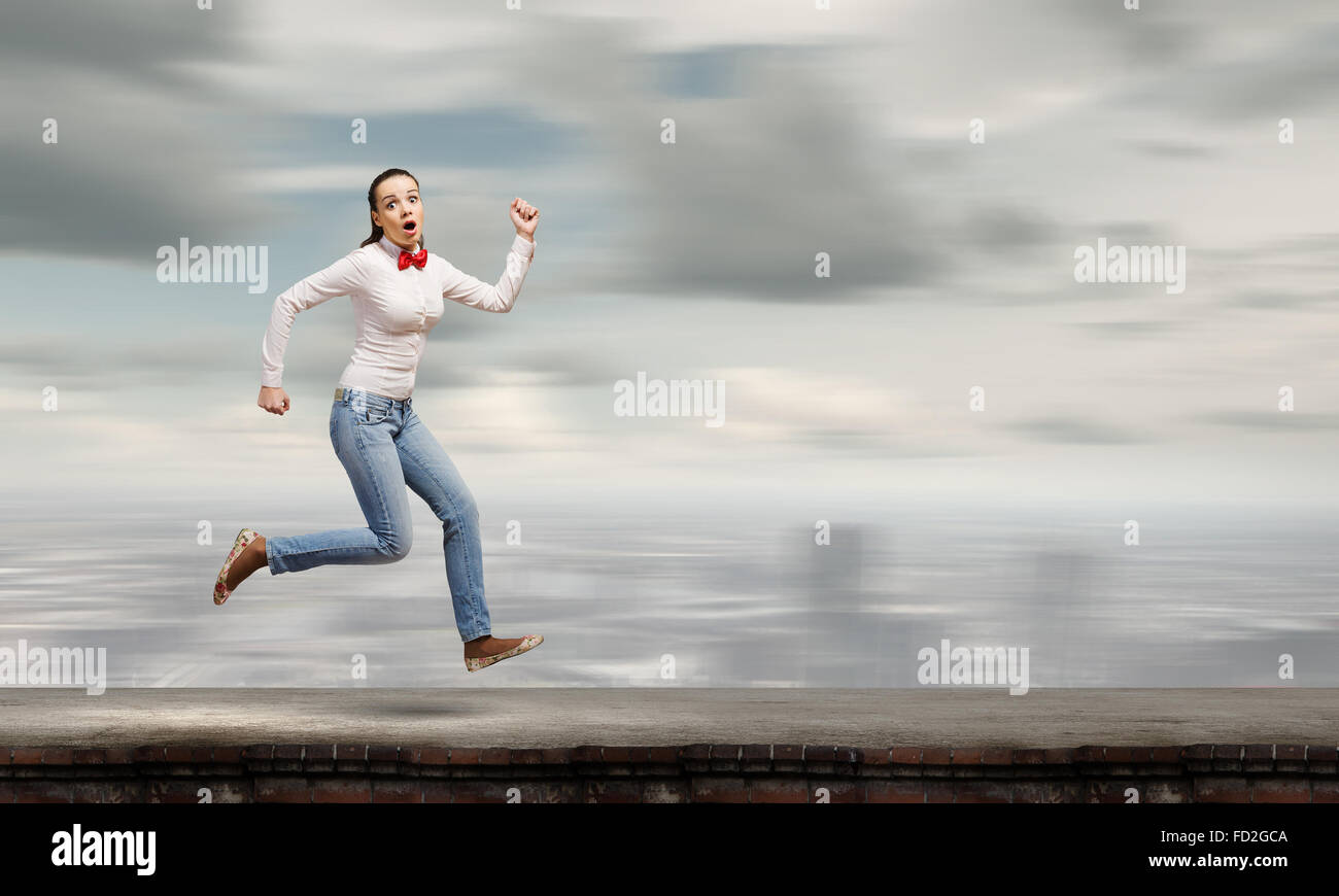 Young funny pretty woman in jeans running in a hurry Stock Photo - Alamy