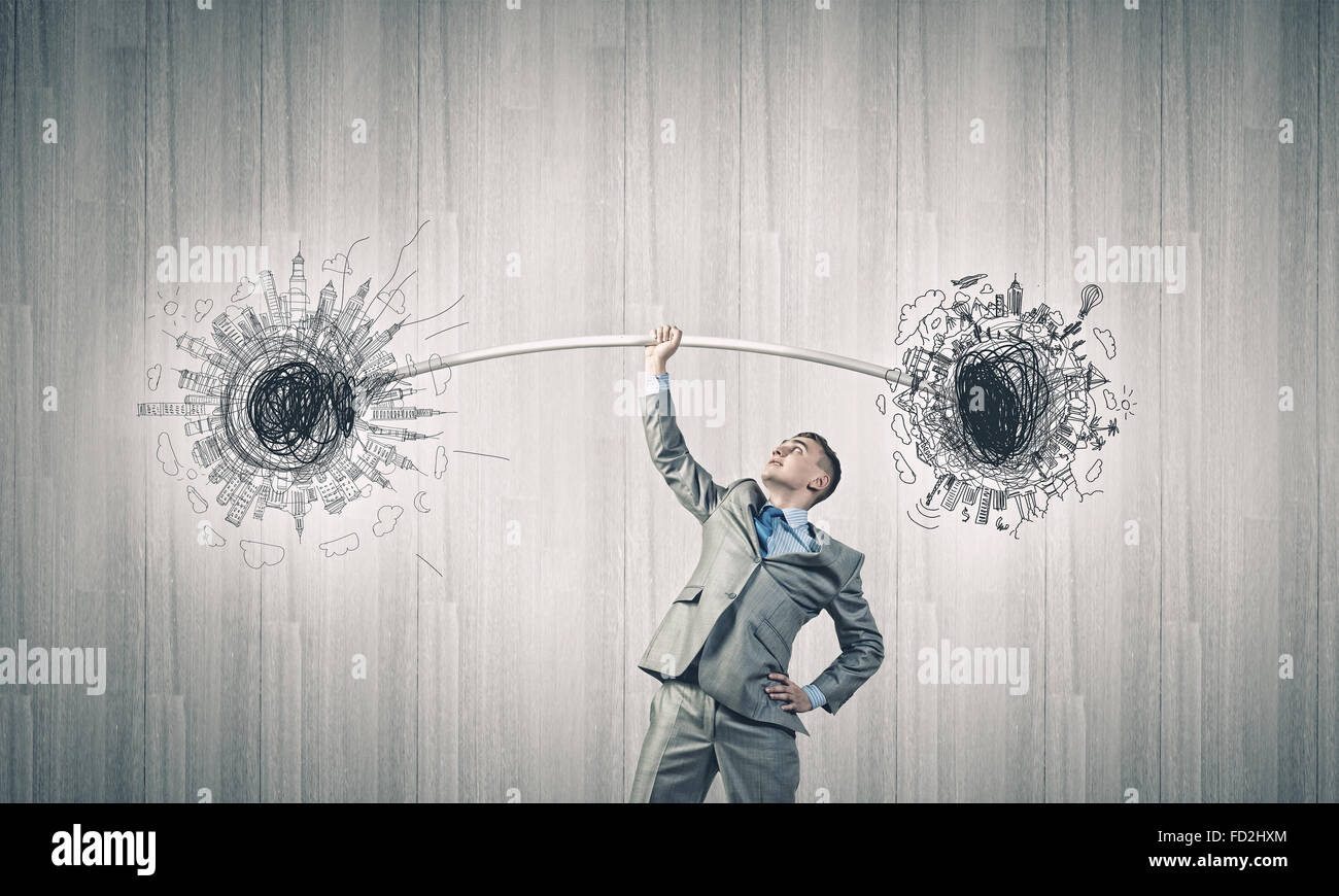 Young strong businessman lifting barbell hi-res stock photography and ...