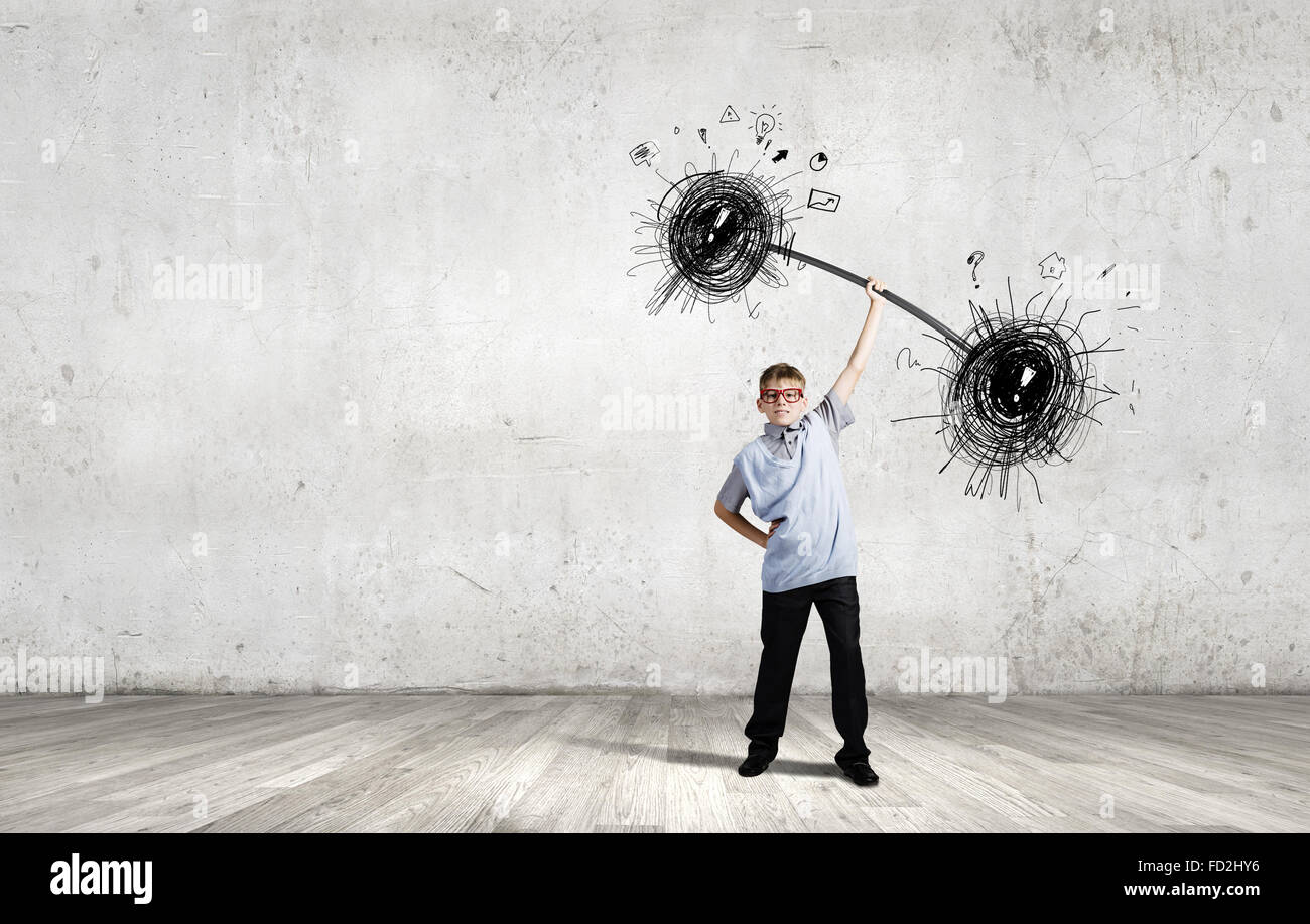 Boy of school age lifting barbell on one hand Stock Photo - Alamy