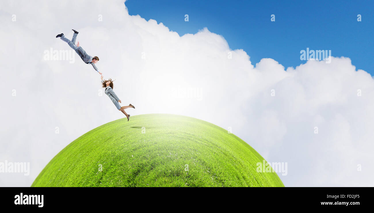 Two young business people flying in sky Stock Photo - Alamy