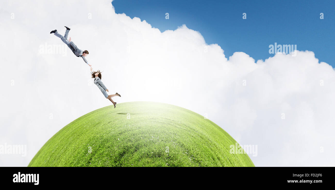 Two young business people flying in sky Stock Photo - Alamy