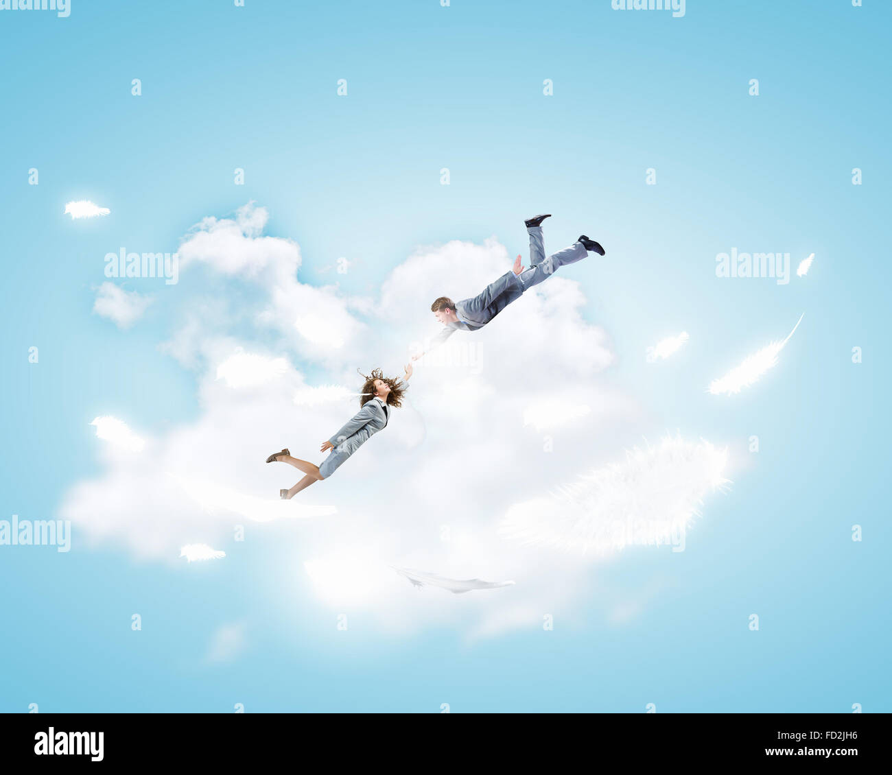 Two young business people flying in sky Stock Photo - Alamy