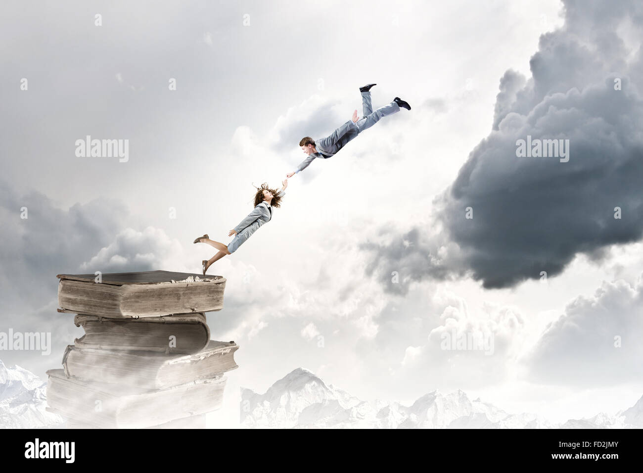 Two young business people flying in sky Stock Photo - Alamy