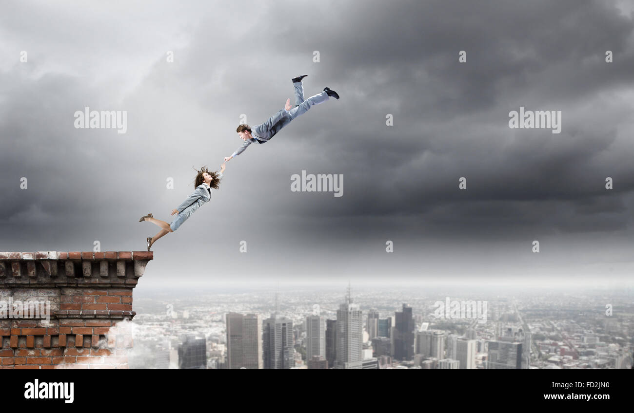 Two young business people flying in sky Stock Photo - Alamy