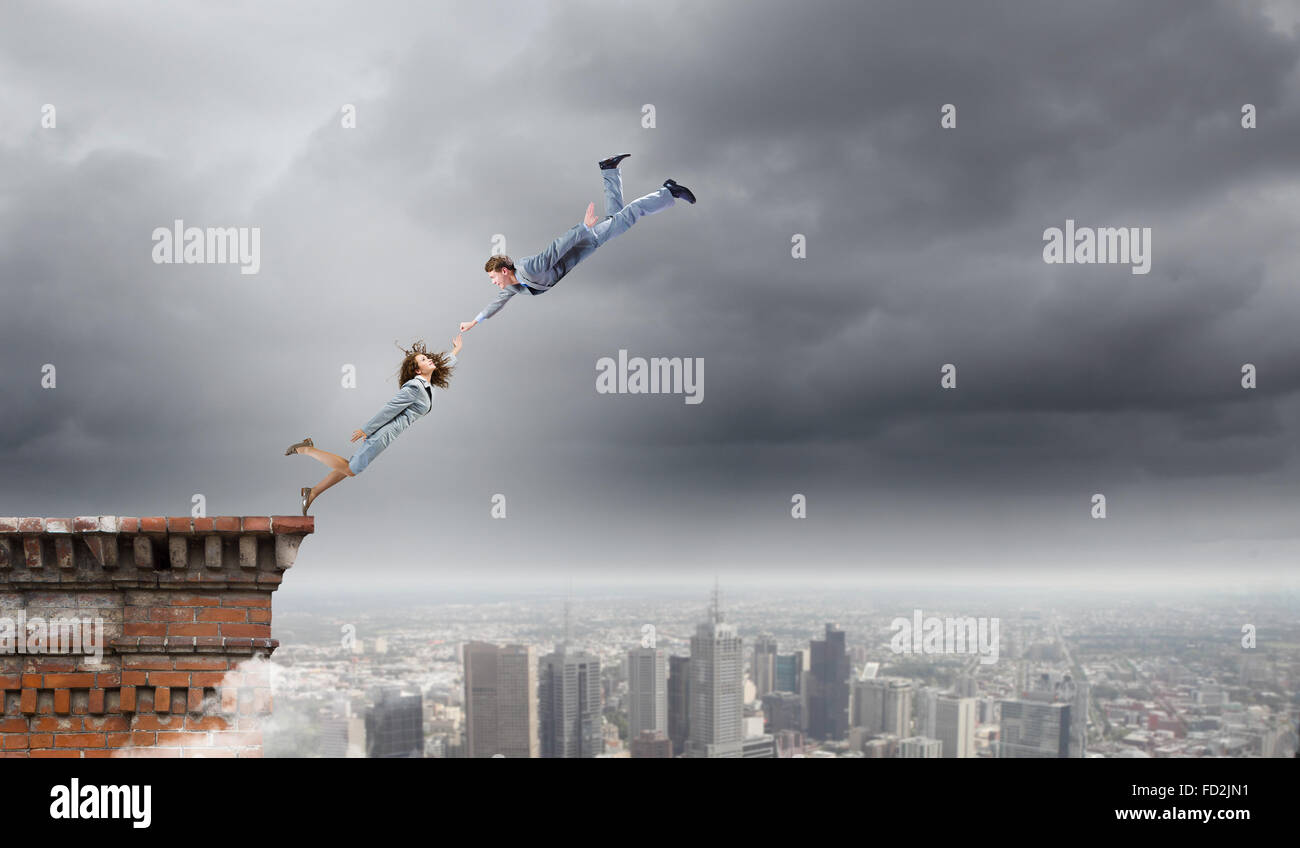 Two young business people flying in sky Stock Photo - Alamy