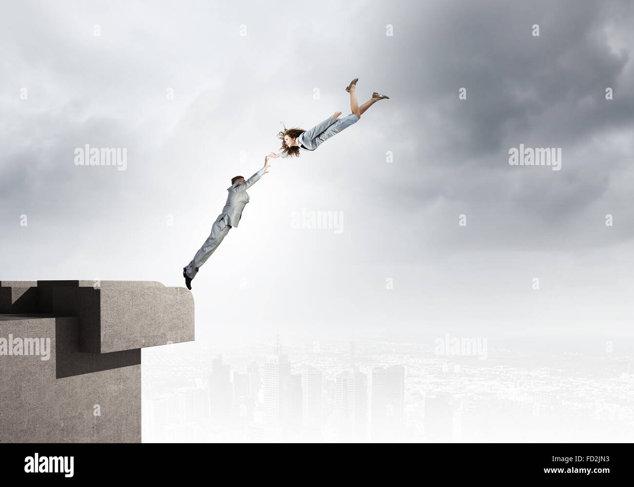 Two young business people flying in sky Stock Photo - Alamy