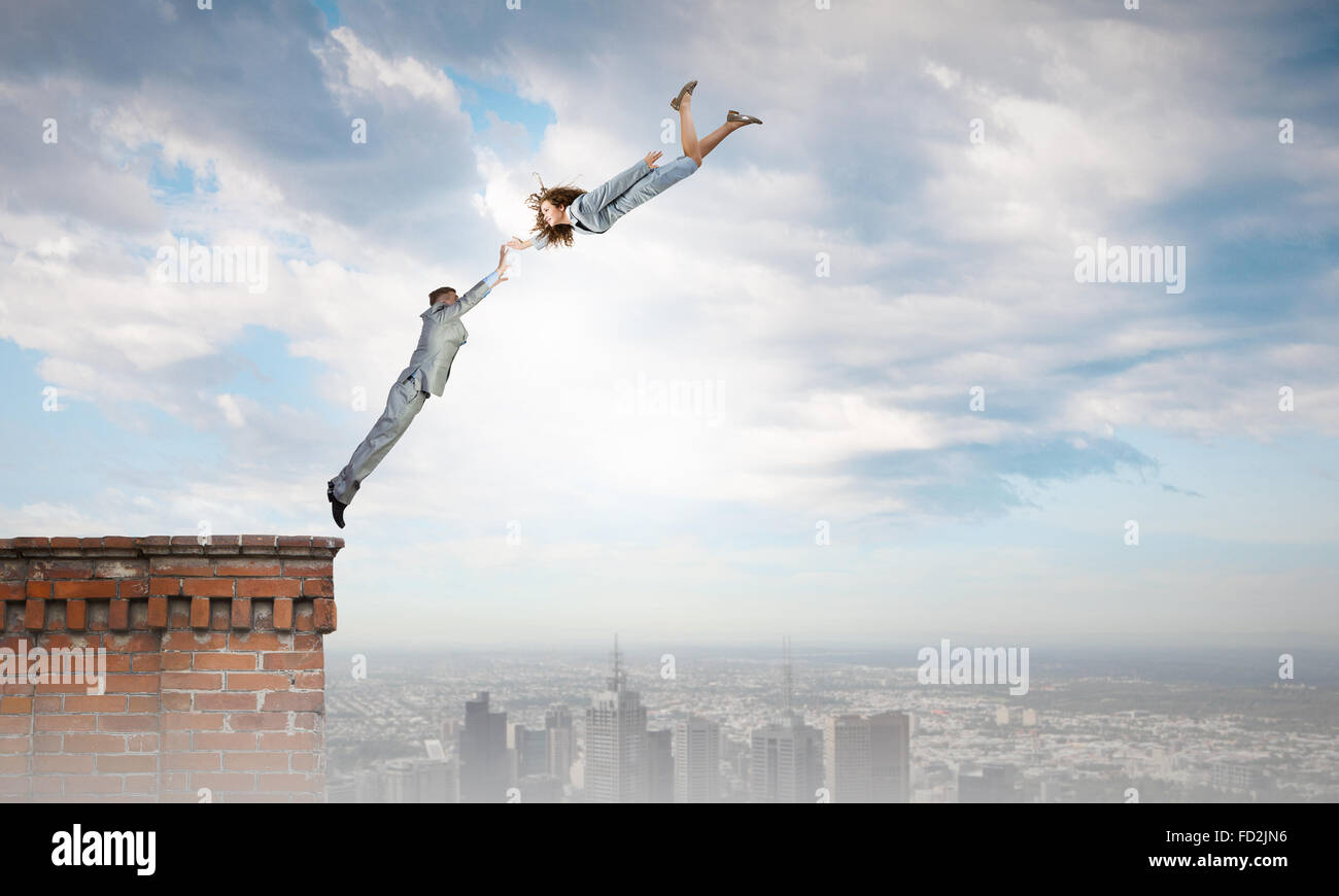 Two young business people flying in sky Stock Photo - Alamy