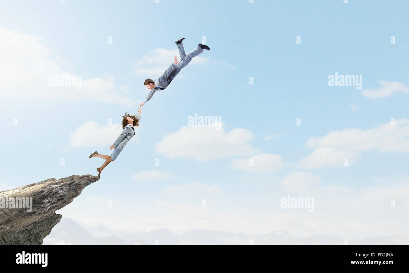 Two young business people flying in sky Stock Photo - Alamy