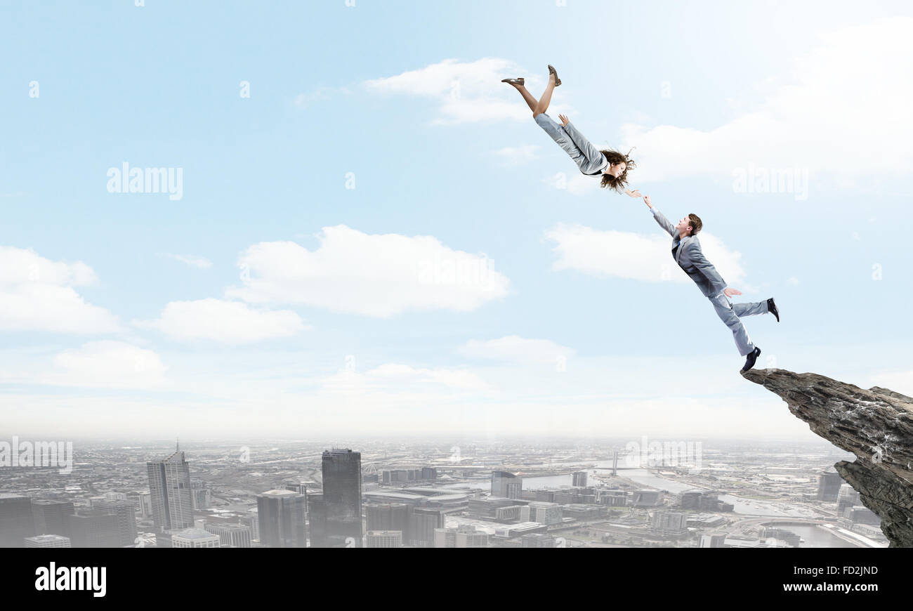 Two young business people flying in sky Stock Photo - Alamy