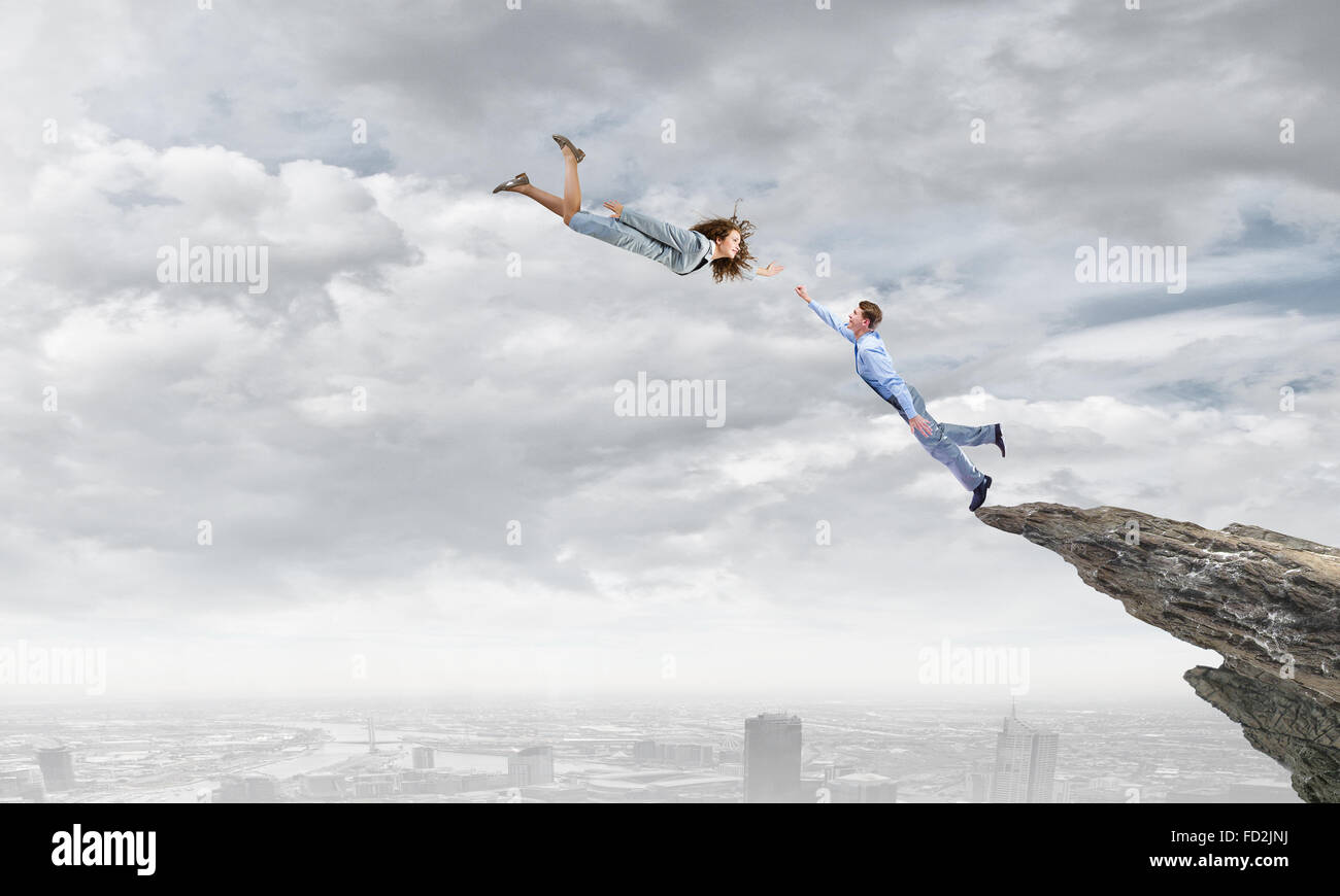 Two young business people flying in sky Stock Photo - Alamy