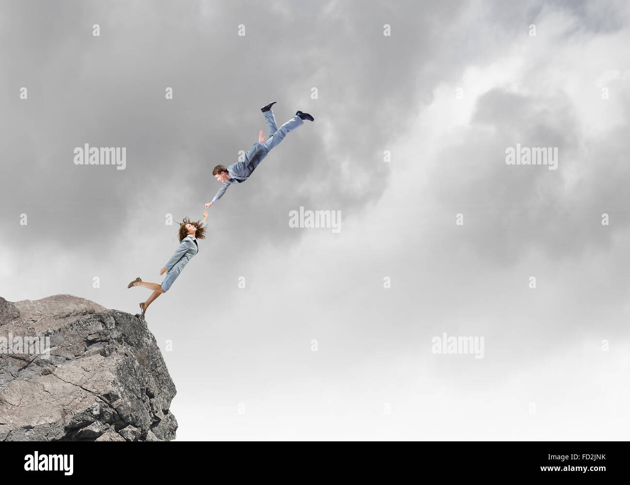Two young business people flying in sky Stock Photo - Alamy