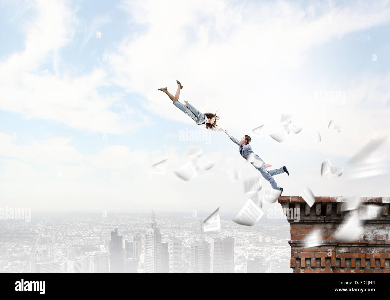 Two young business people flying in sky Stock Photo - Alamy