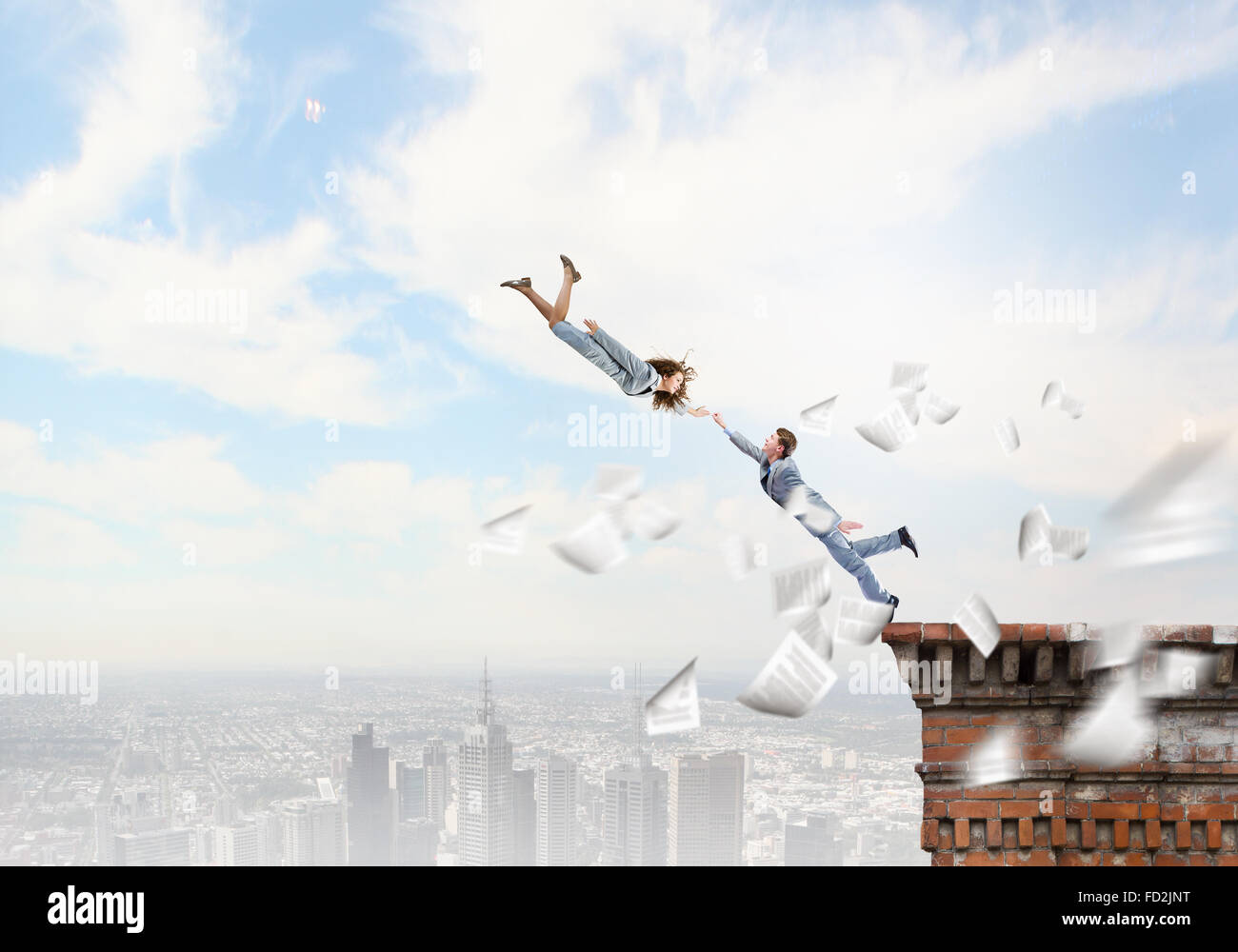 Two young business people flying in sky Stock Photo - Alamy