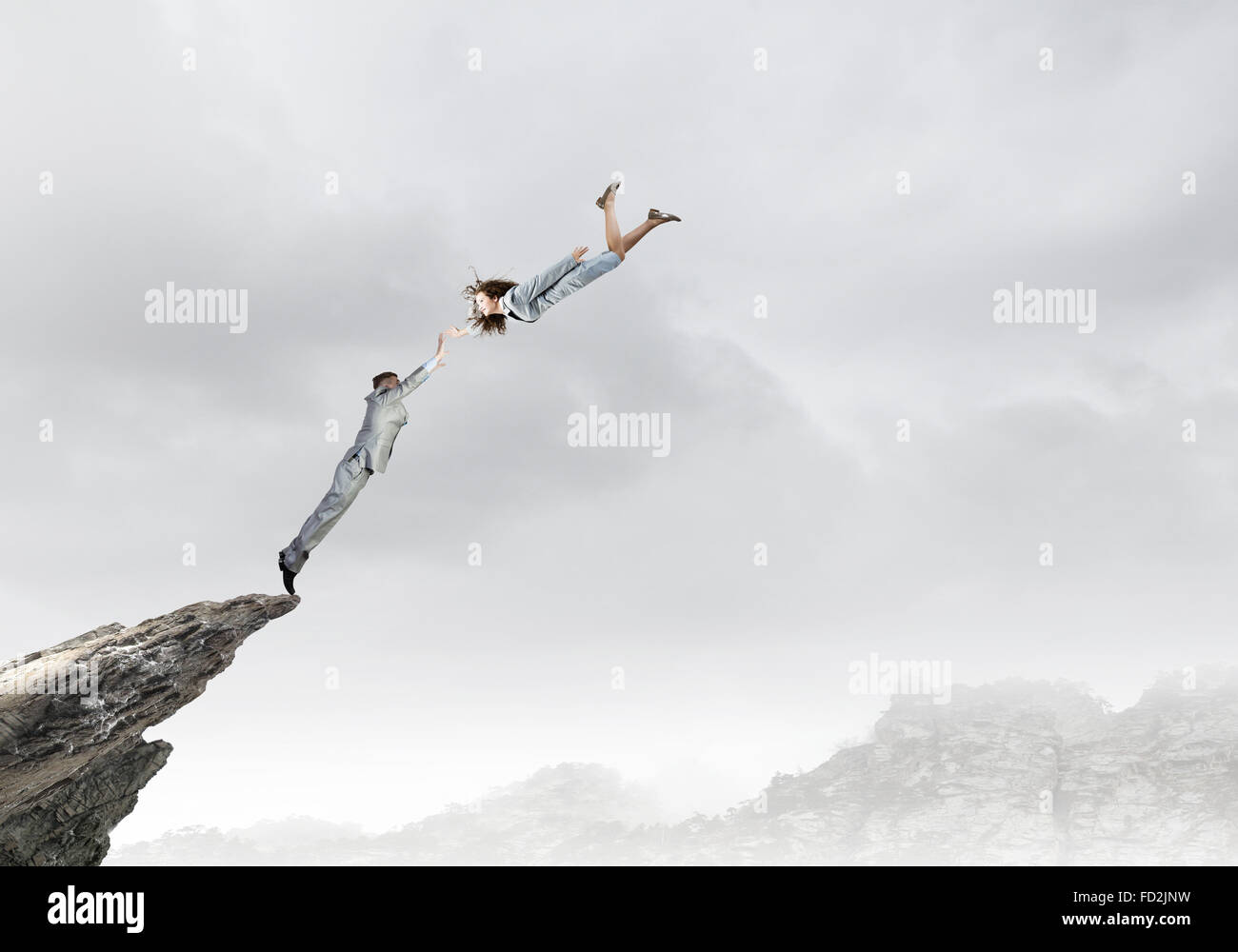 Two young business people flying in sky Stock Photo - Alamy