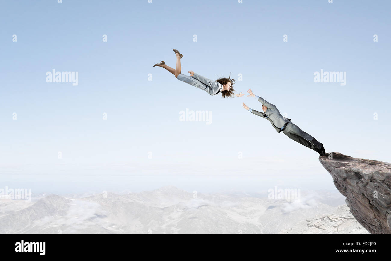 Two young business people flying in sky Stock Photo - Alamy