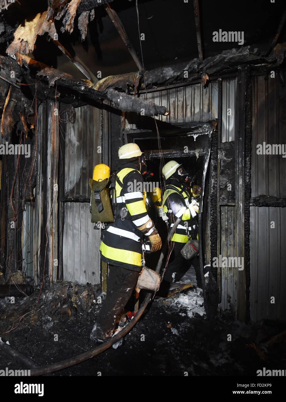 Munich, Germany. 27th Jan, 2016. Fireman at work at a burned living ...
