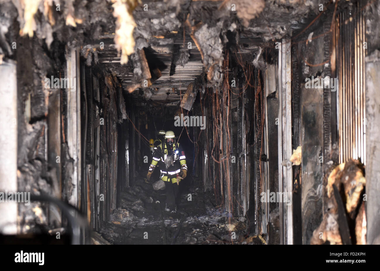Munich, Germany. 27th Jan, 2016. Fireman at work at a burned living ...
