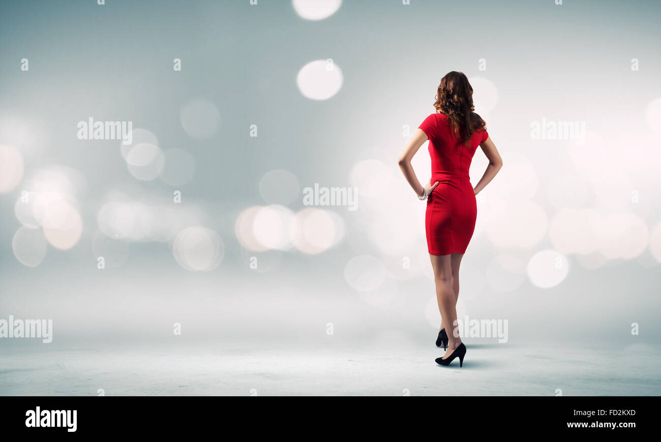 Rear view of young woman in red dress Stock Photo - Alamy