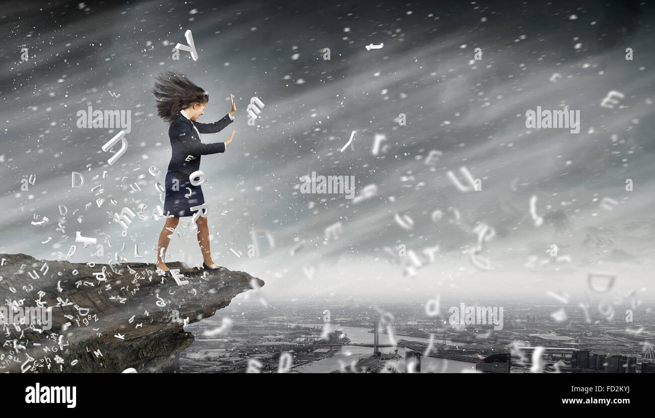 Young determined businesswoman walking against strong wind Stock Photo ...