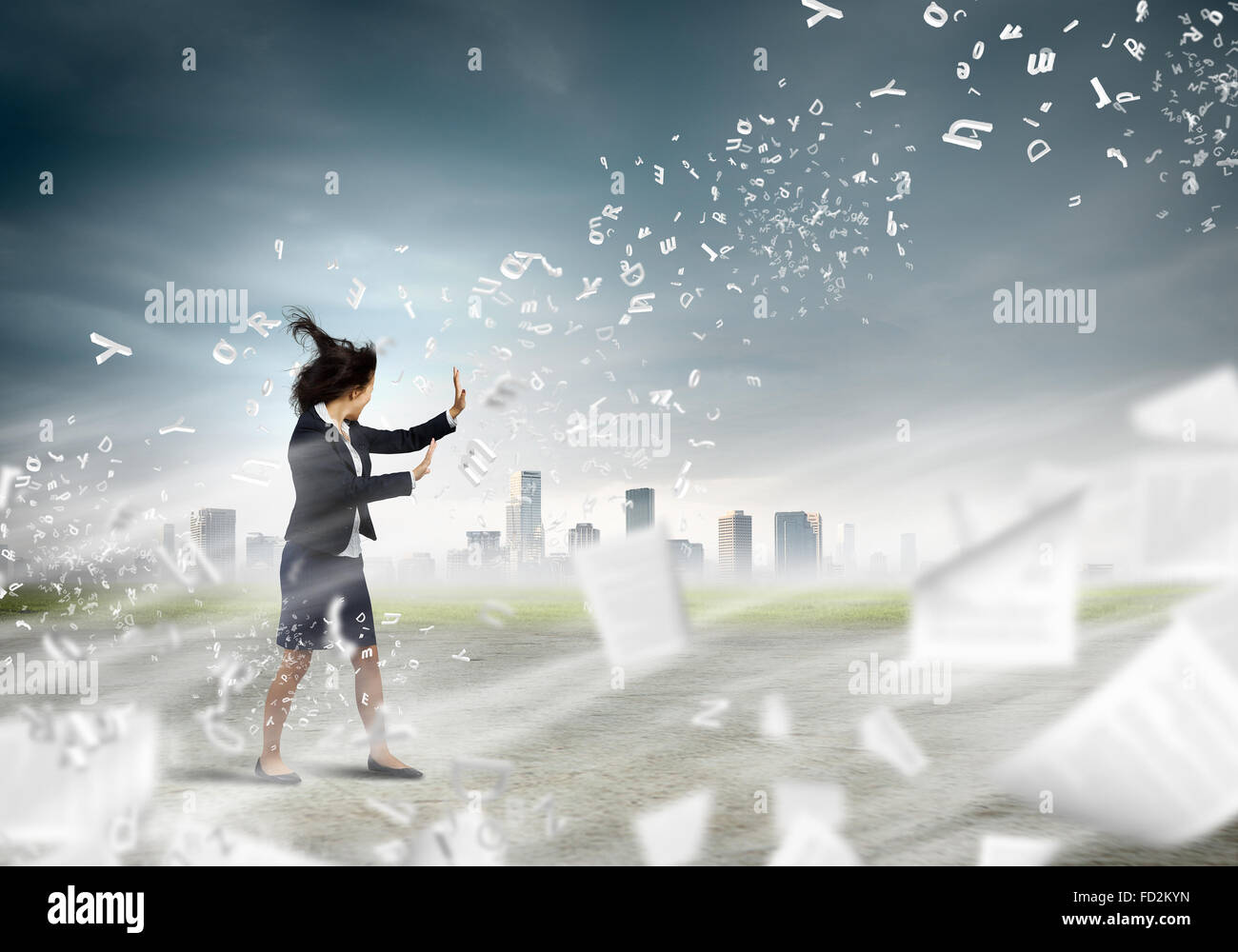 Young determined businesswoman walking against strong wind Stock Photo ...