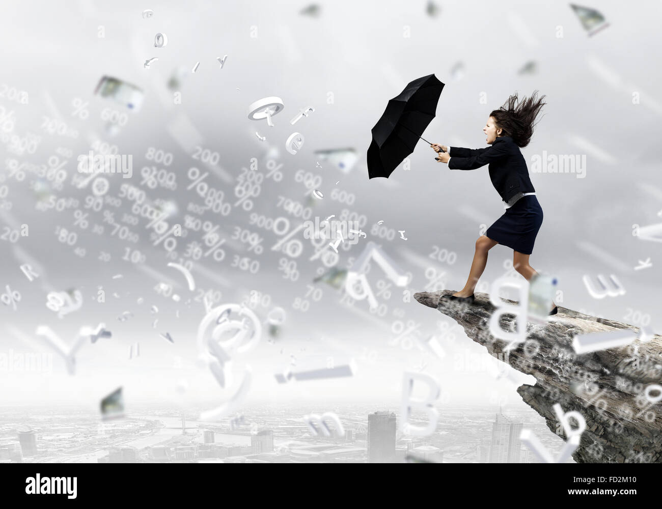 Young determined businesswoman walking against strong wind Stock Photo ...