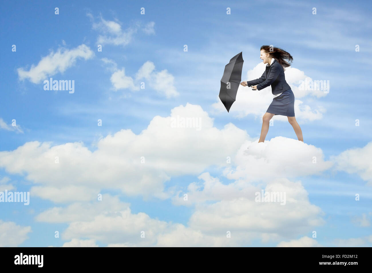Young determined businesswoman walking against strong wind Stock Photo ...
