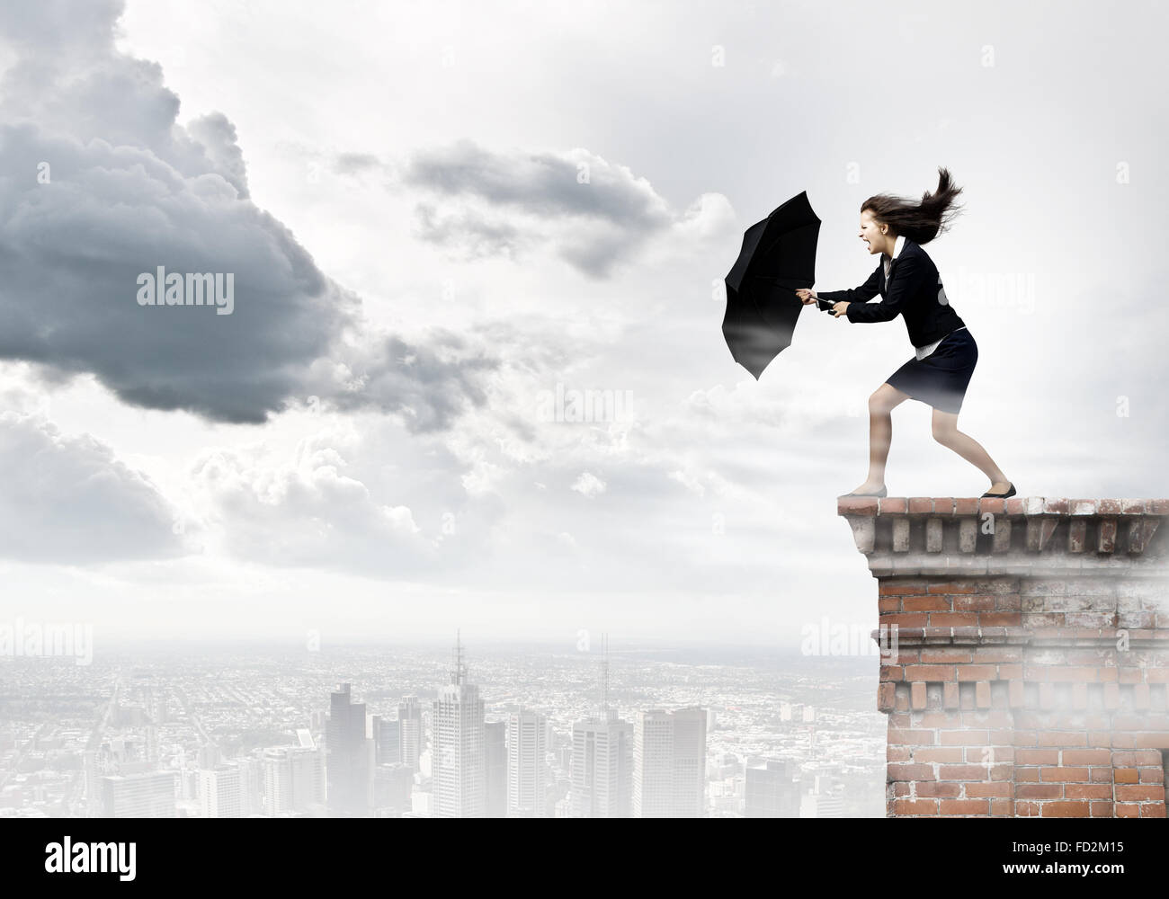 Young determined businesswoman walking against strong wind Stock Photo ...