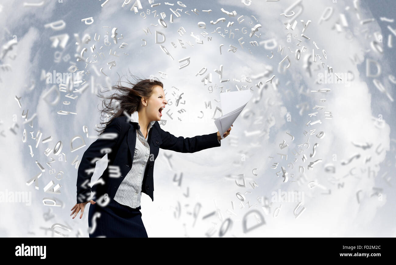 Young determined businesswoman walking against strong wind Stock Photo ...