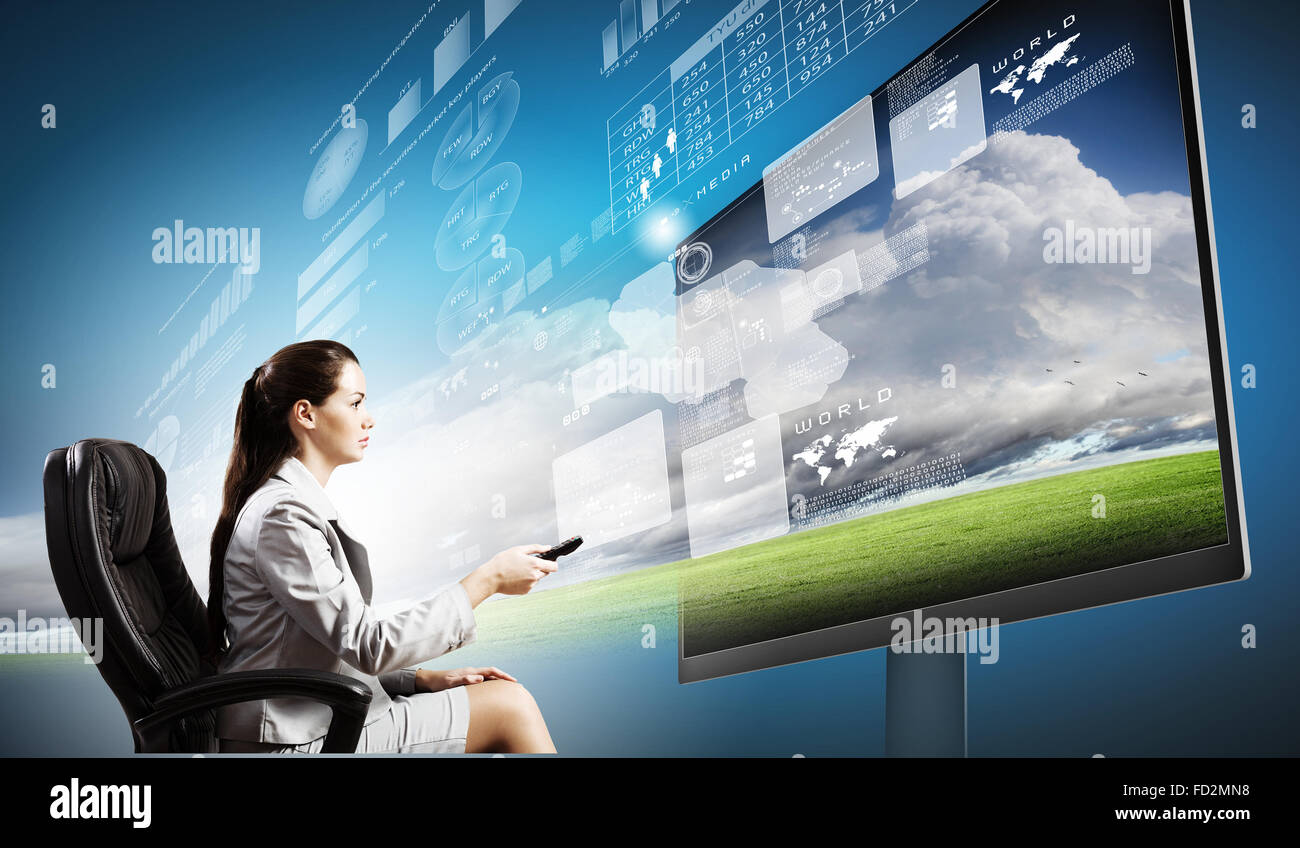 Young businesswoman in chair near tv screen with click Stock Photo - Alamy